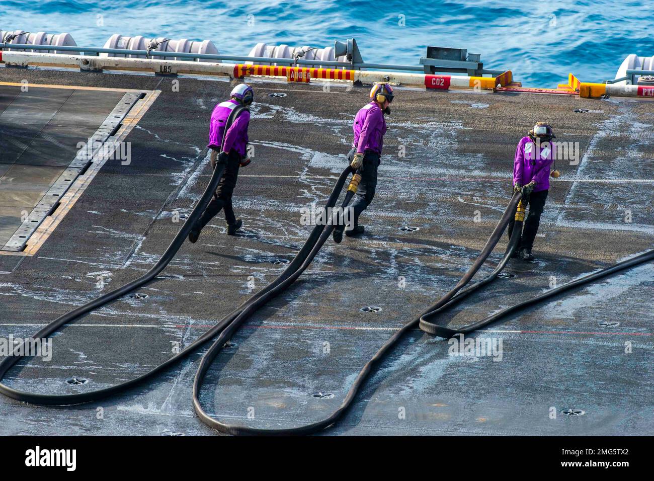 South China Sea. 20th Jan, 2023. U.S. Navy Sailors haul a jet fuel hose ...