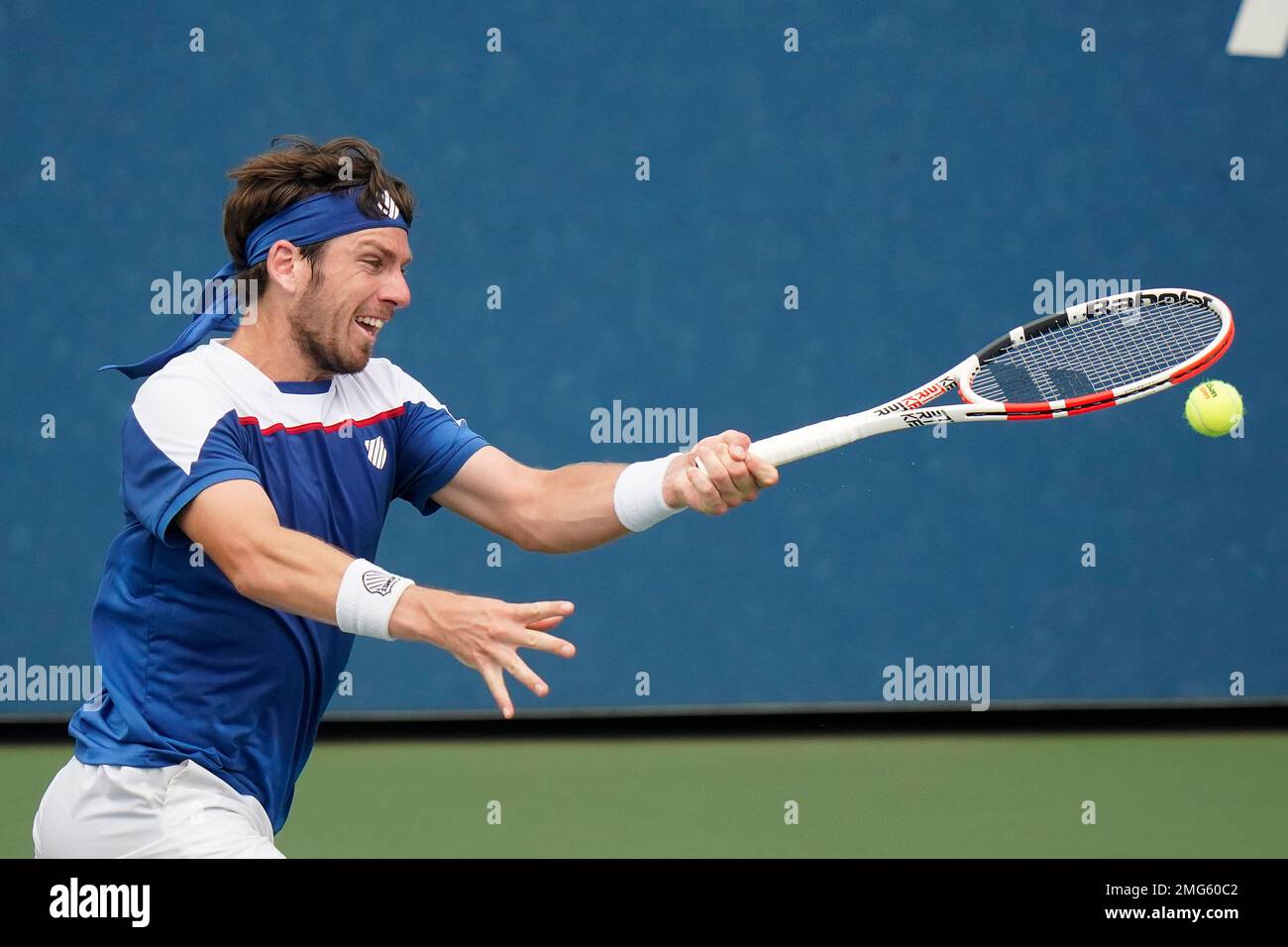 Cameron Norris, of Great Britain, returns a shot to Diego Schwartzman ...