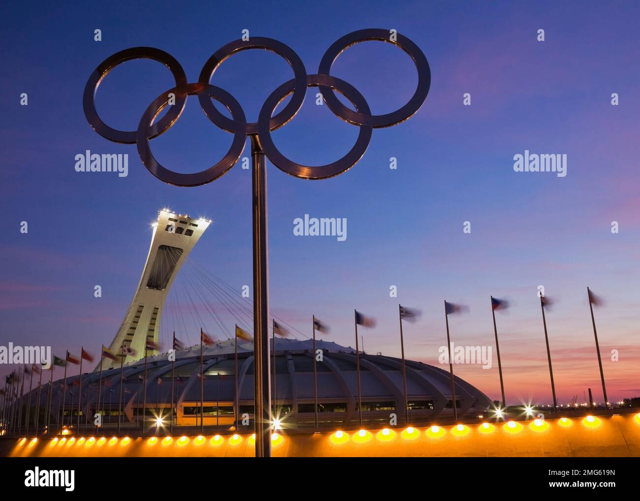 Metal olympic rings sculpture and Olympic Stadium with inclined tower ...