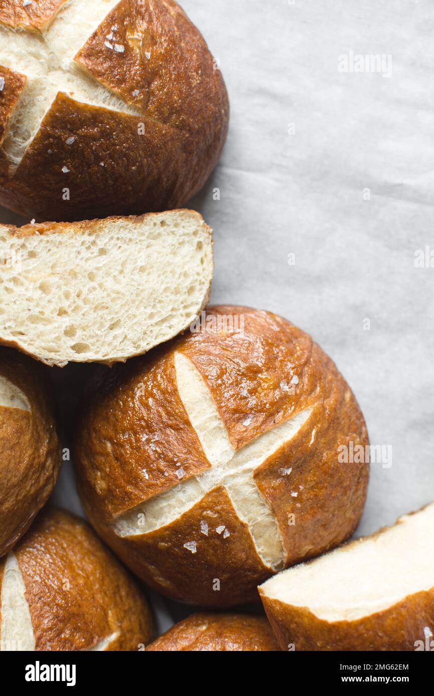 Top view of Pretzel buns on a parchment lined baking sheet, German ...