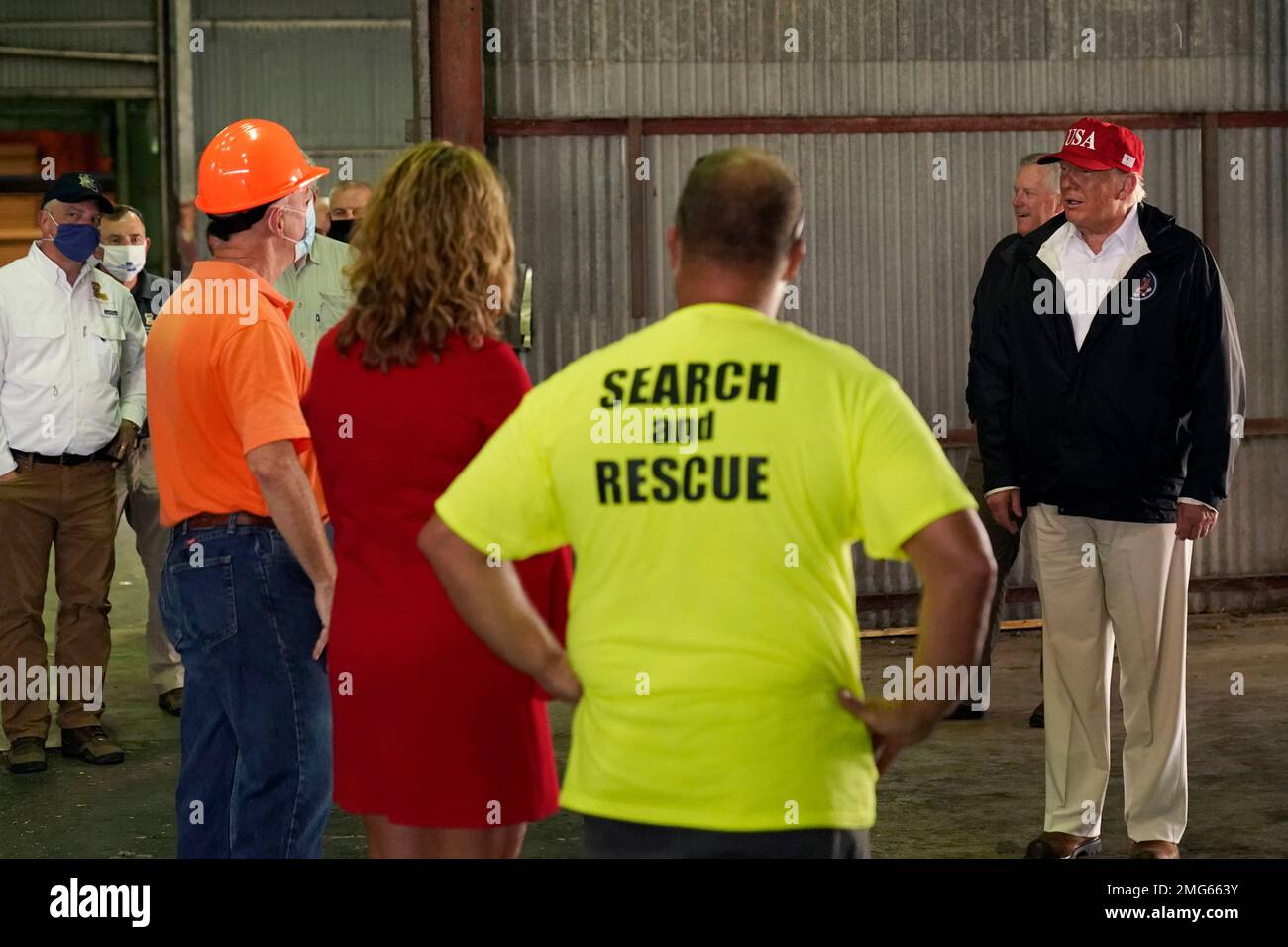President Donald Trump speaks with first responders as he tours a ...