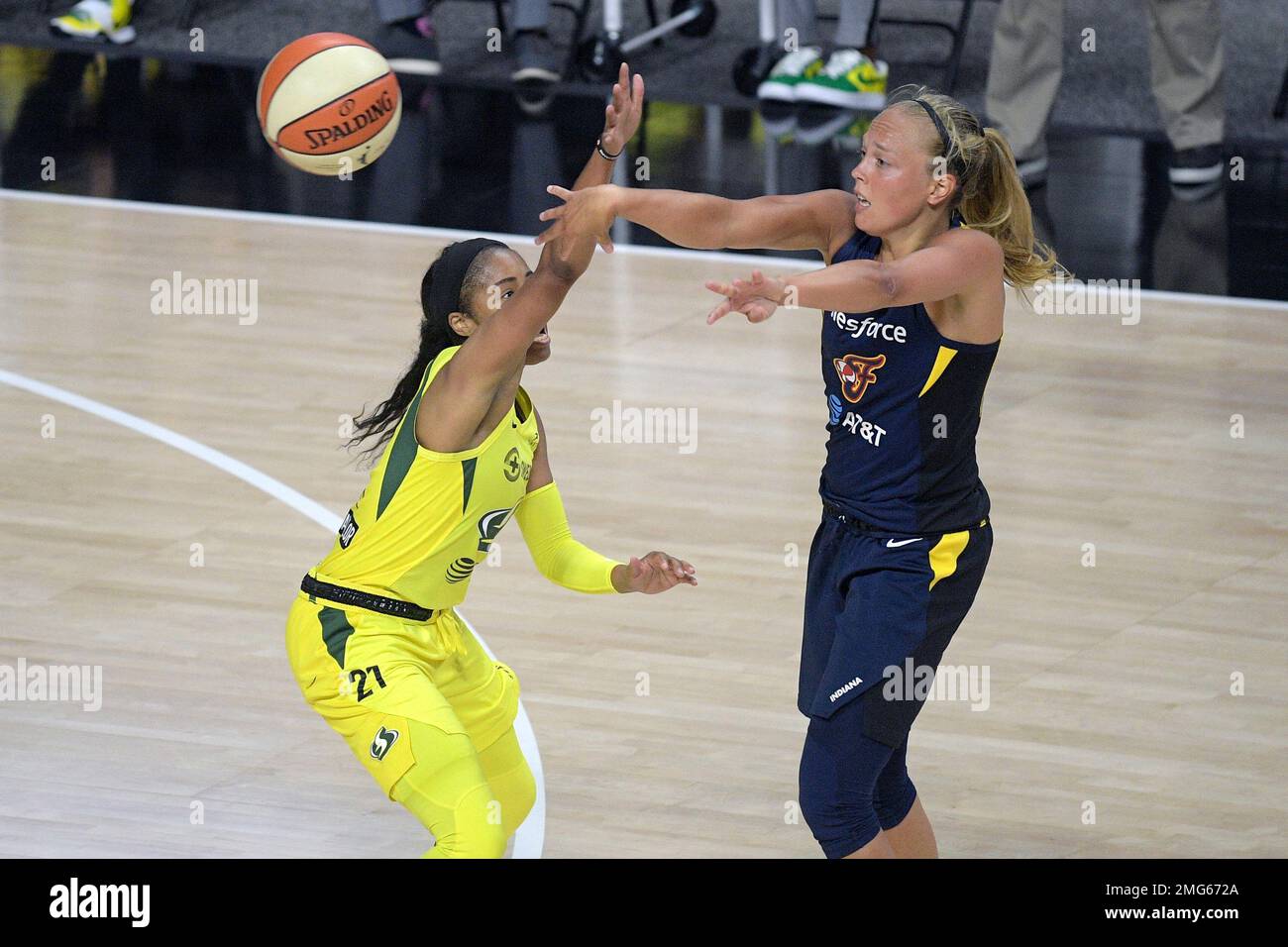 Indiana Fever guard Julie Allemand, right, passes the ball in front of ...
