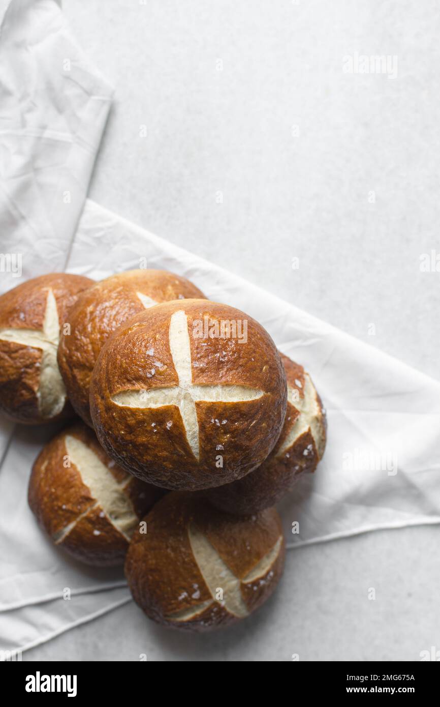 Top view of Pretzel buns on a marble tray, German laugenbroetchen on a ...
