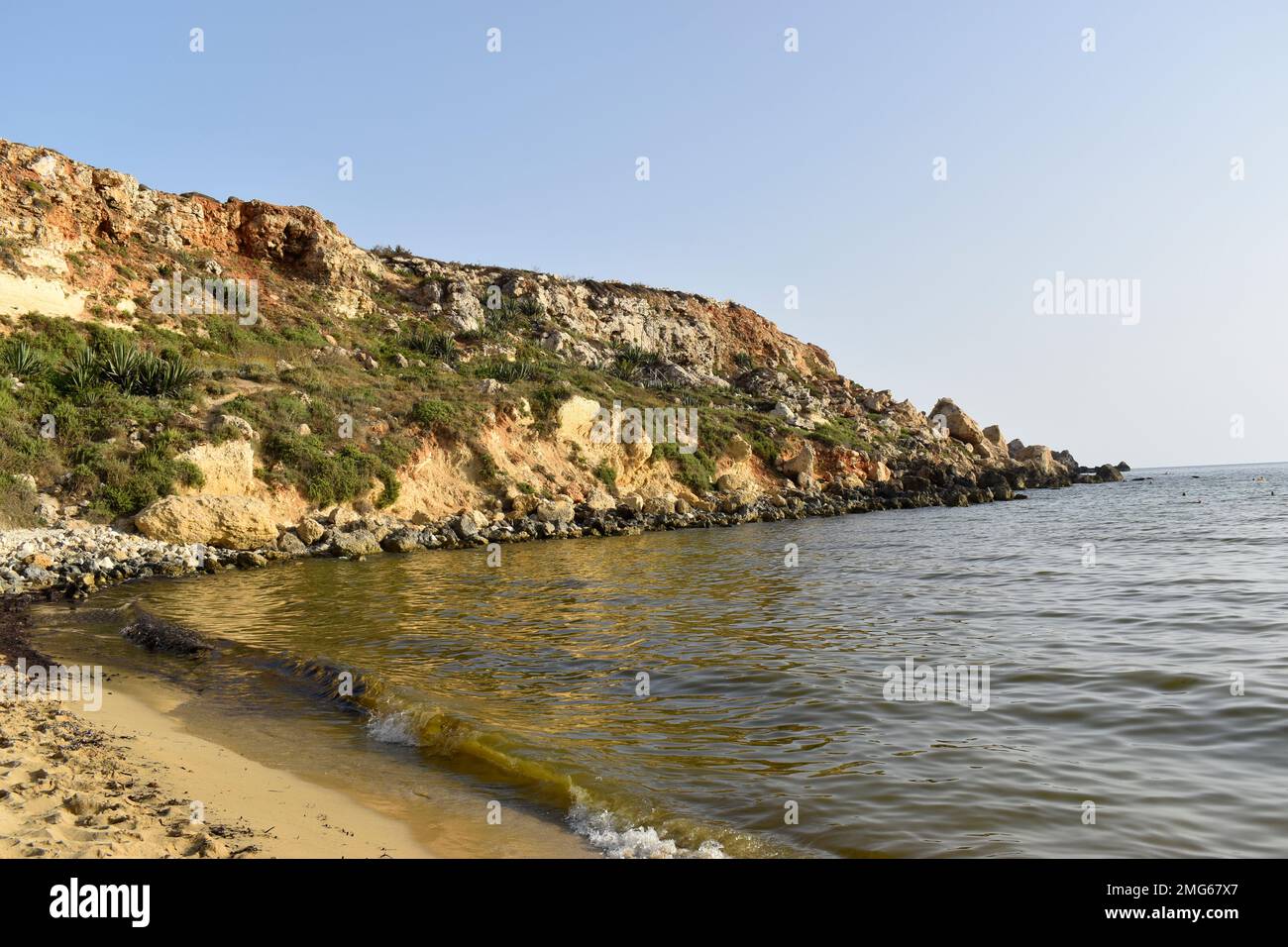 Beautiful beach in Malta, Europe. Golden reflection of sand, rocks and ...