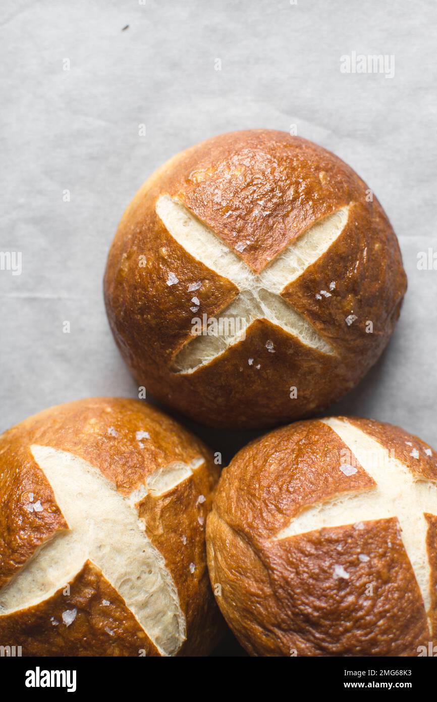 Top view of Pretzel buns on a parchment lined baking sheet, German ...