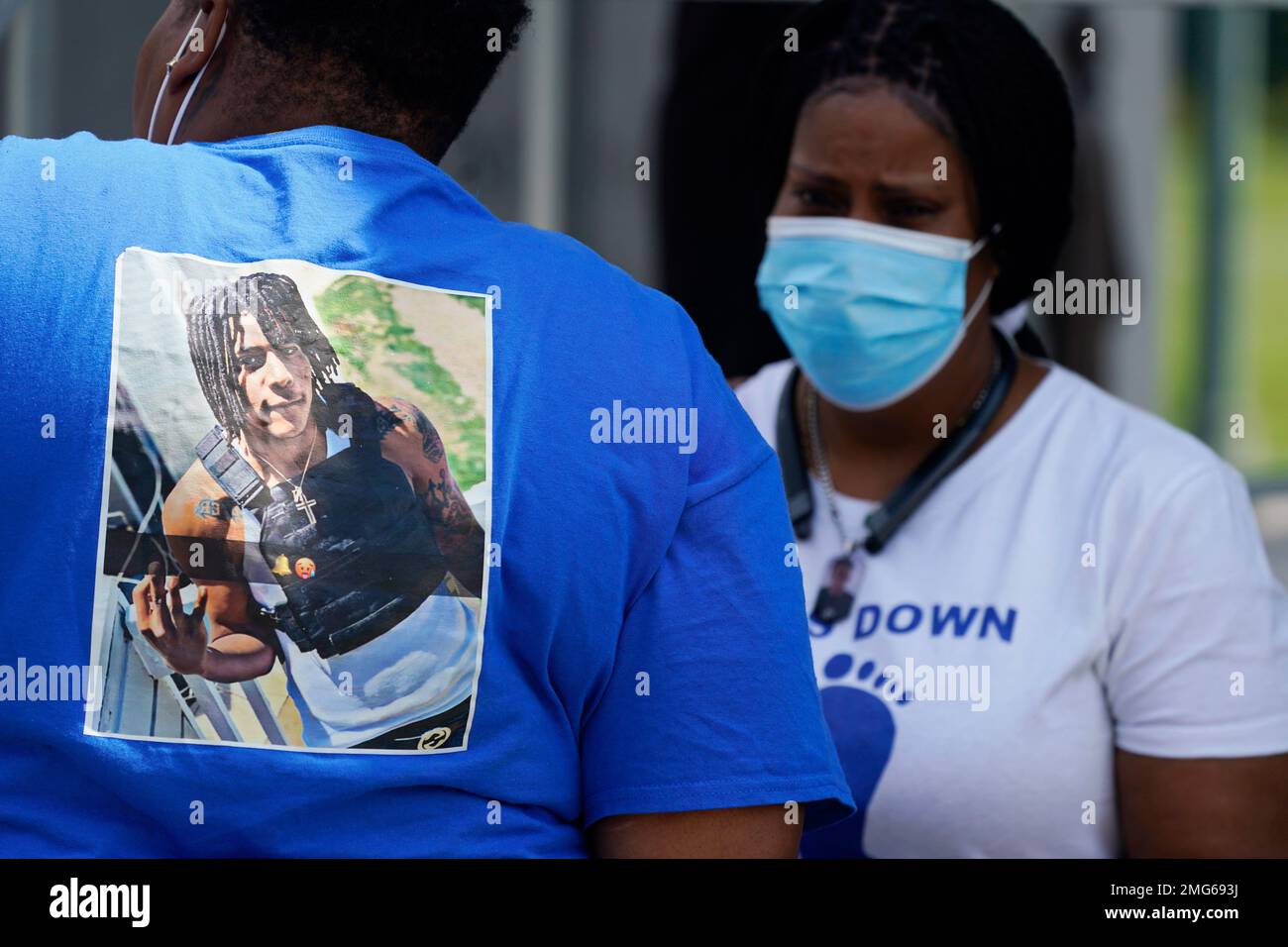 A photograph of Darrell Mitchell is displayed on the back of a T-shirt ...
