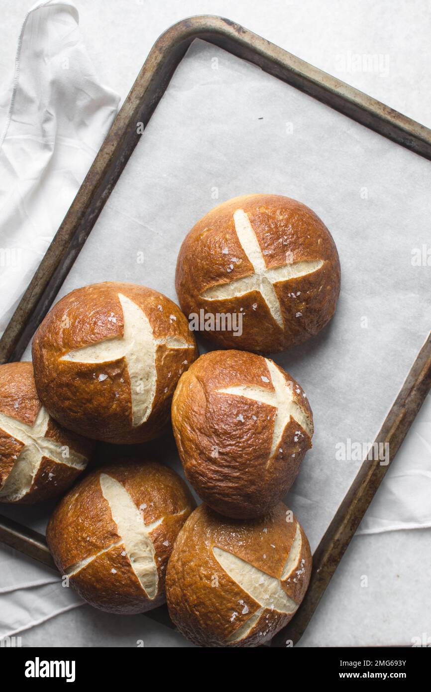 Top view of Pretzel buns on a parchment lined baking sheet, German ...