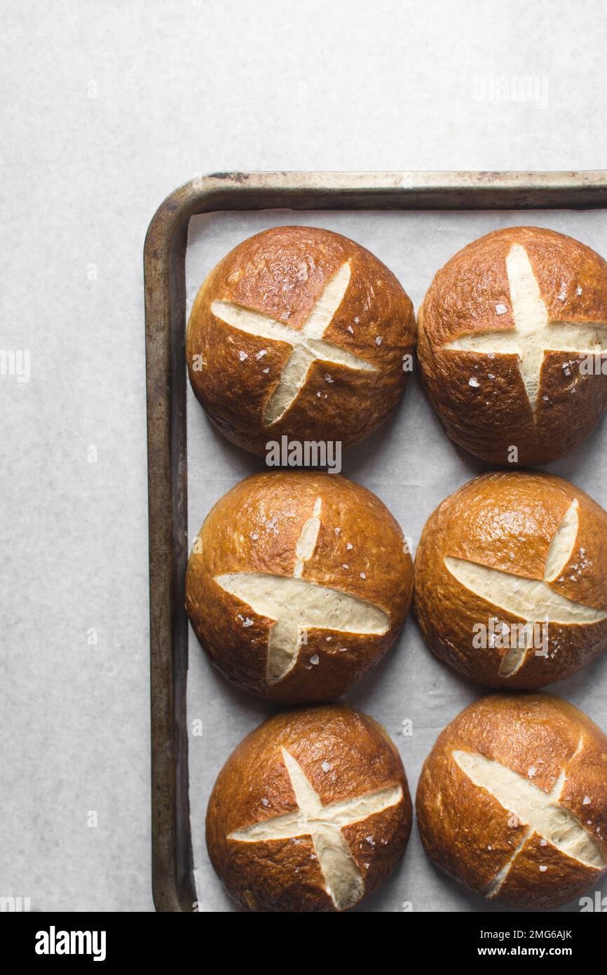 Top view of Pretzel buns on a parchment lined baking sheet, German ...