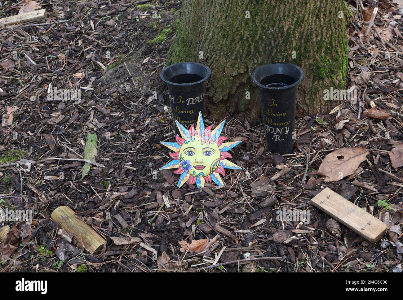 A colourful Sun face laid on the ground in a garden of remembrance ...
