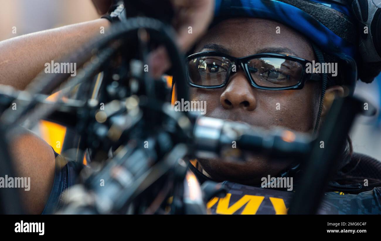 U.S. Army Pfc. Corine Hamilton adjusts her helmet before the cycling ...