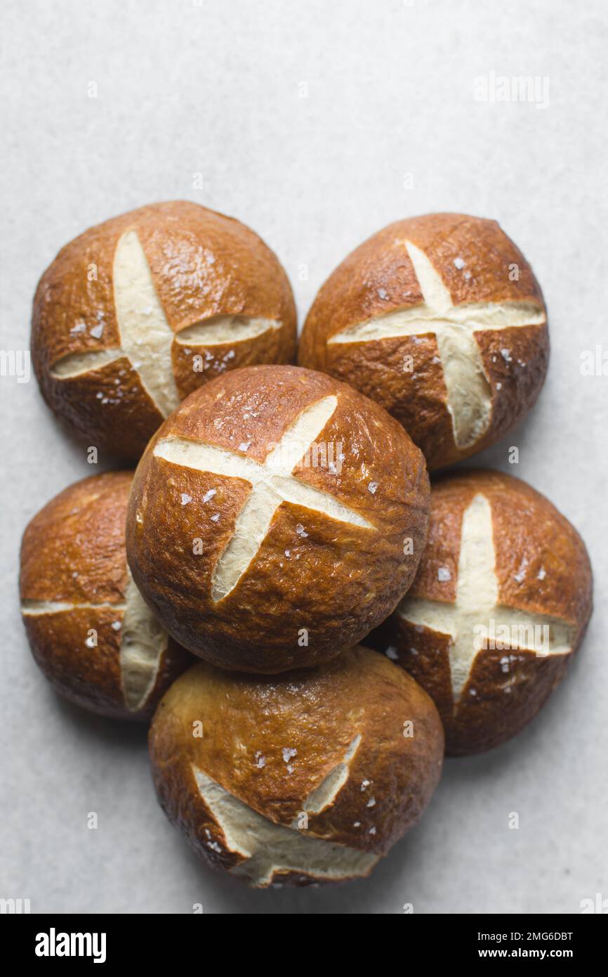 Top view of Pretzel buns on a marble tray, German laugenbroetchen on a ...