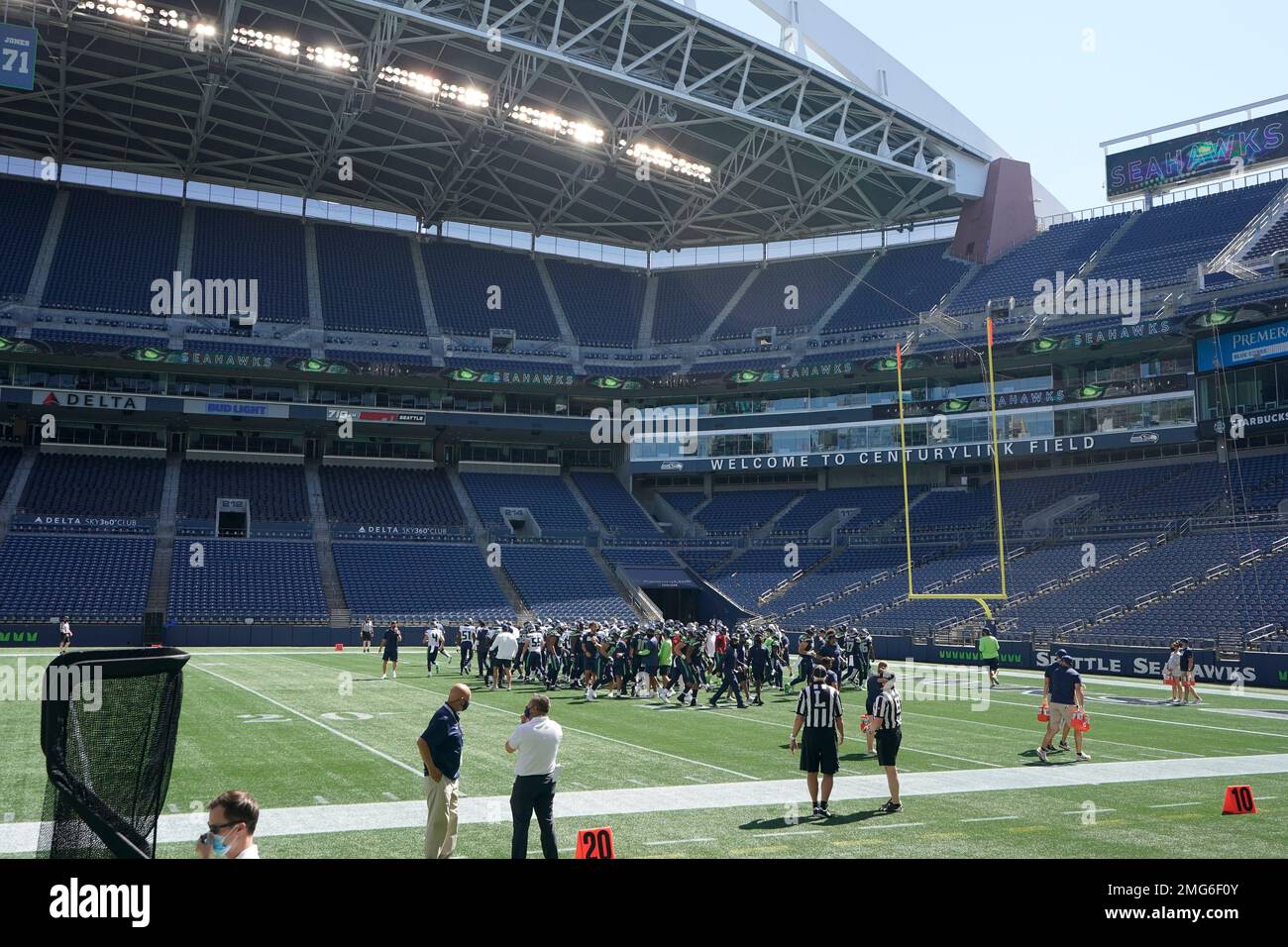 Seattle Seahawks players huddle near empty seats at CenturyLink Field ...