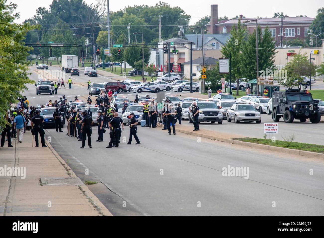 Police officers form a barricade of police cars during the Good Trouble ...