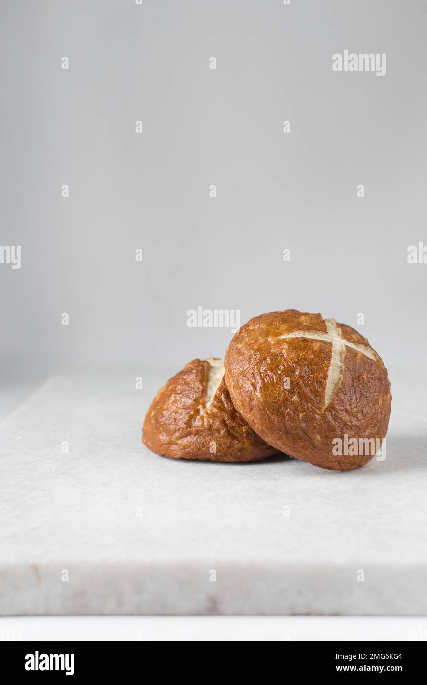 Top view of Pretzel buns on a marble tray, German laugenbroetchen on a ...