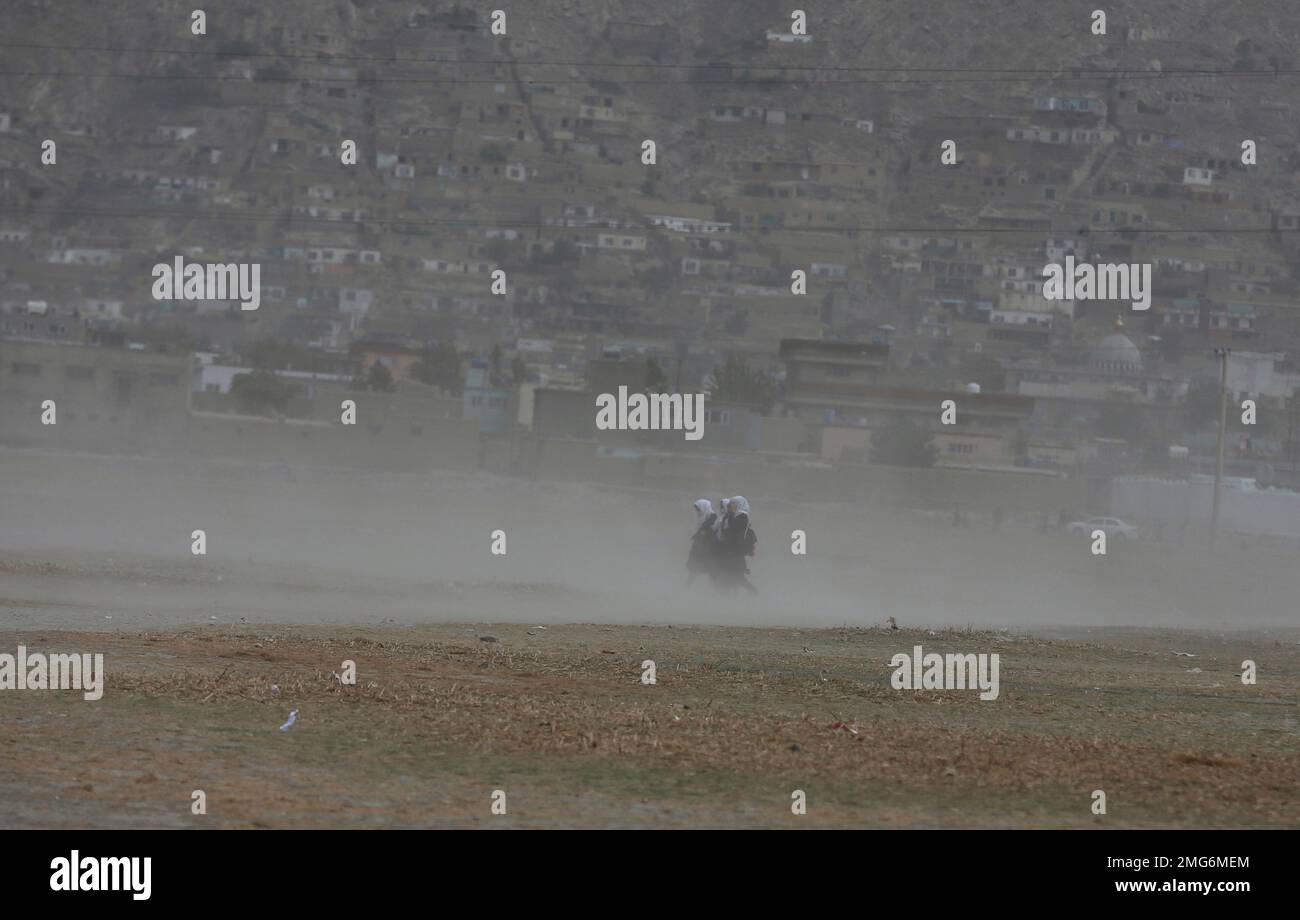 Afghan schoolgirls walk during sand storm on the outskirts of Kabul ...