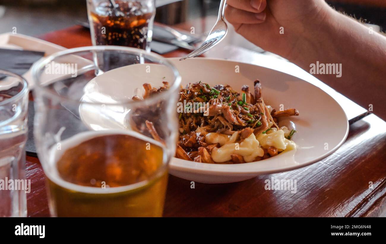 Freshly cooked Canadian dish putin with chicken and cheese. French ...