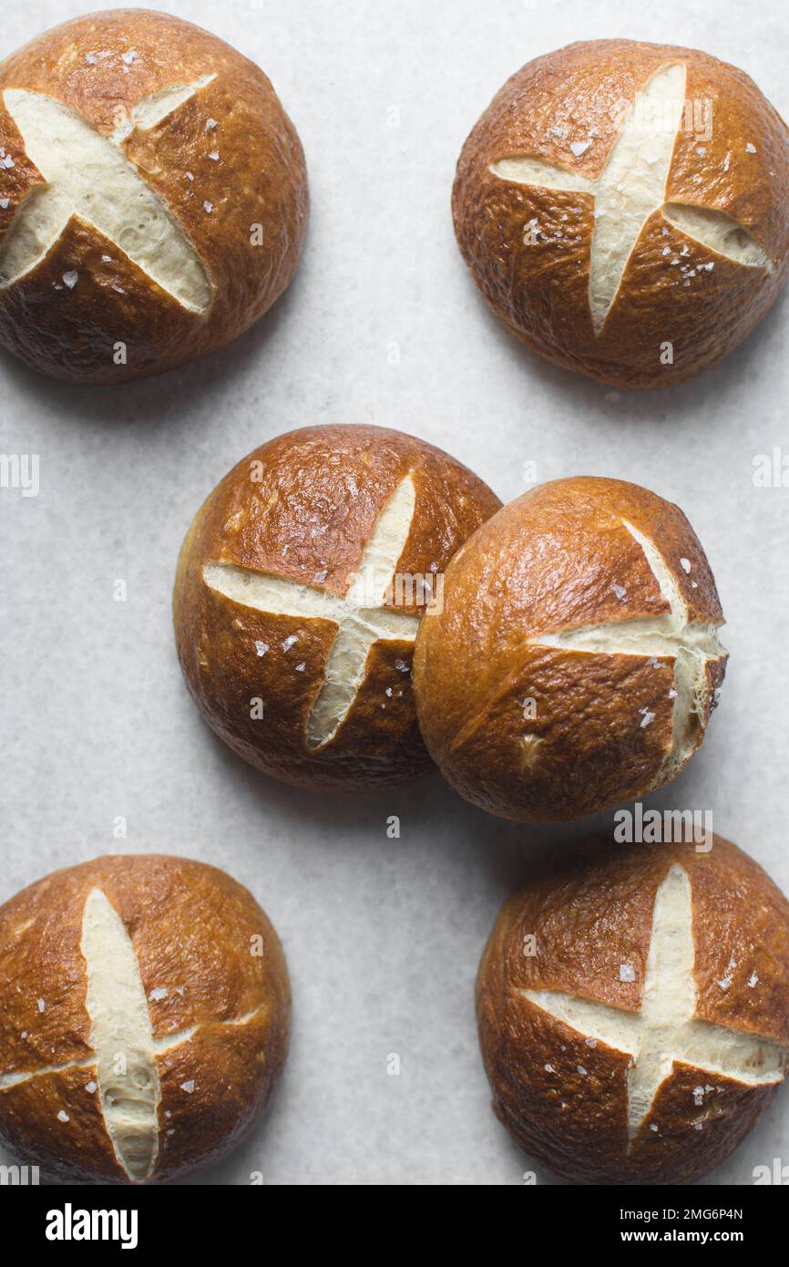 Top view of Pretzel buns on a marble tray, German laugenbroetchen on a ...