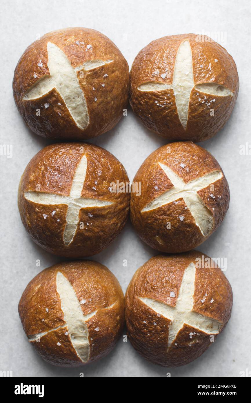 Top view of Pretzel buns on a marble tray, German laugenbroetchen on a ...