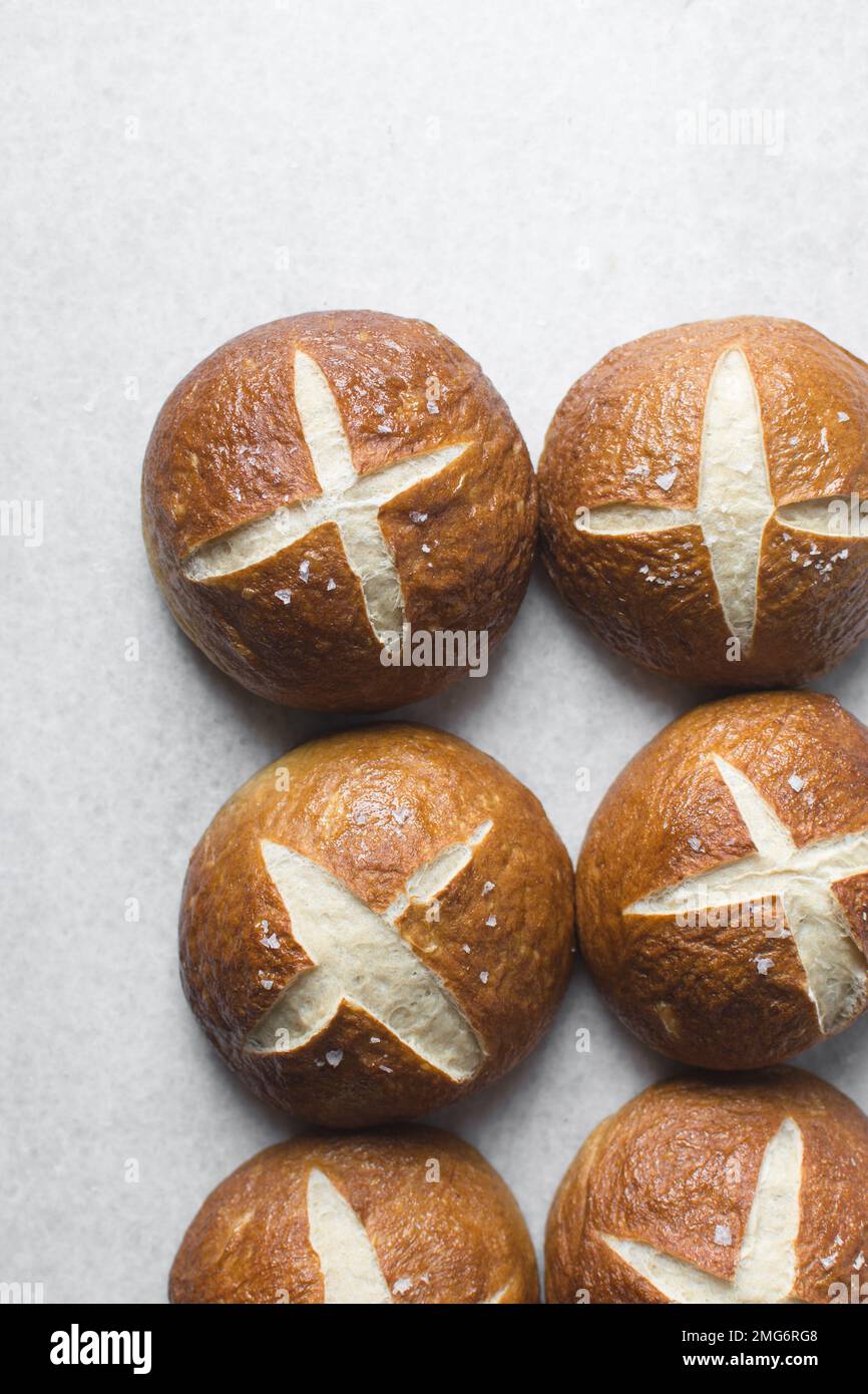Top view of Pretzel buns on a marble tray, German laugenbroetchen on a ...