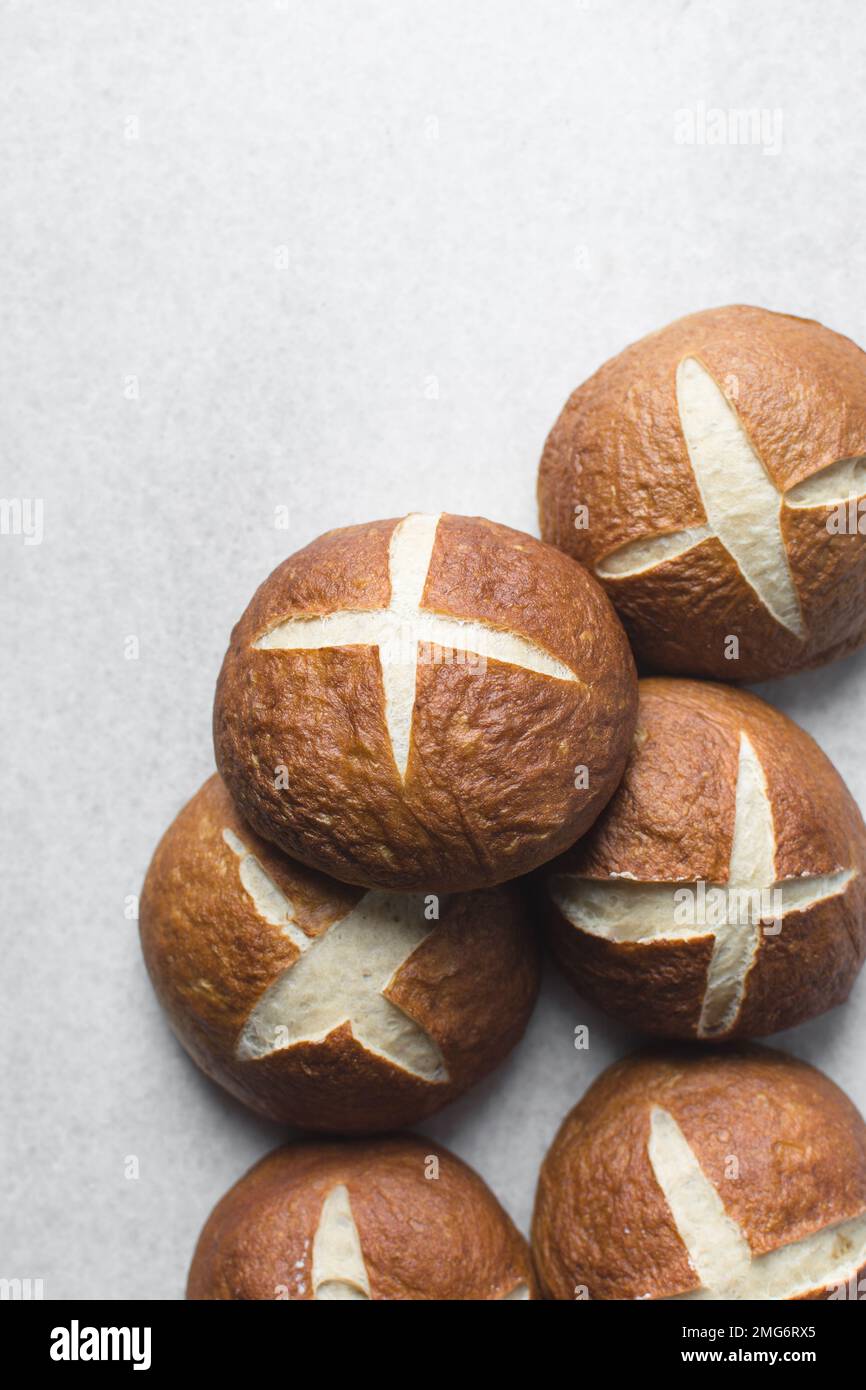 Top view of Pretzel buns on a marble tray, German laugenbroetchen on a ...