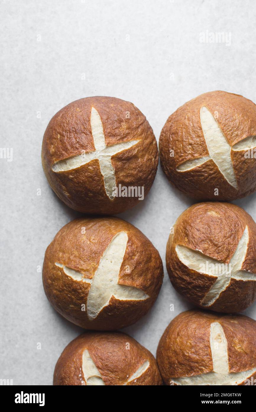 Top view of Pretzel buns on a marble tray, German laugenbroetchen on a ...