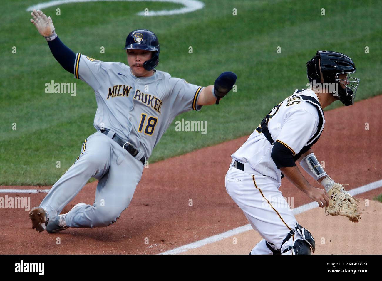 Milwaukee Brewers' Keston Hiura (18) scores on a double by Justin Smoak ...