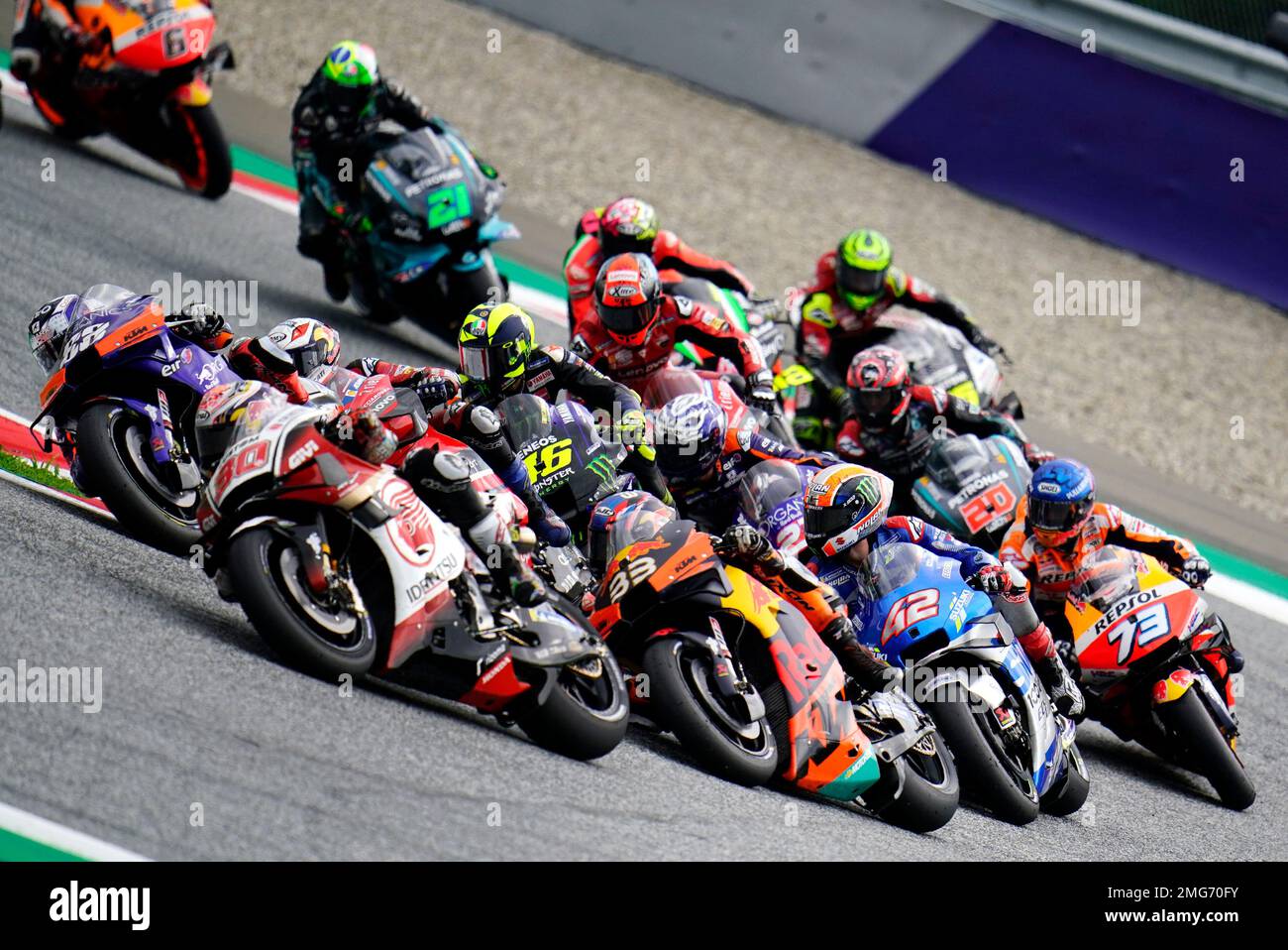 Mocorcycle drivers come around the curve during the MotoGP race at the ...