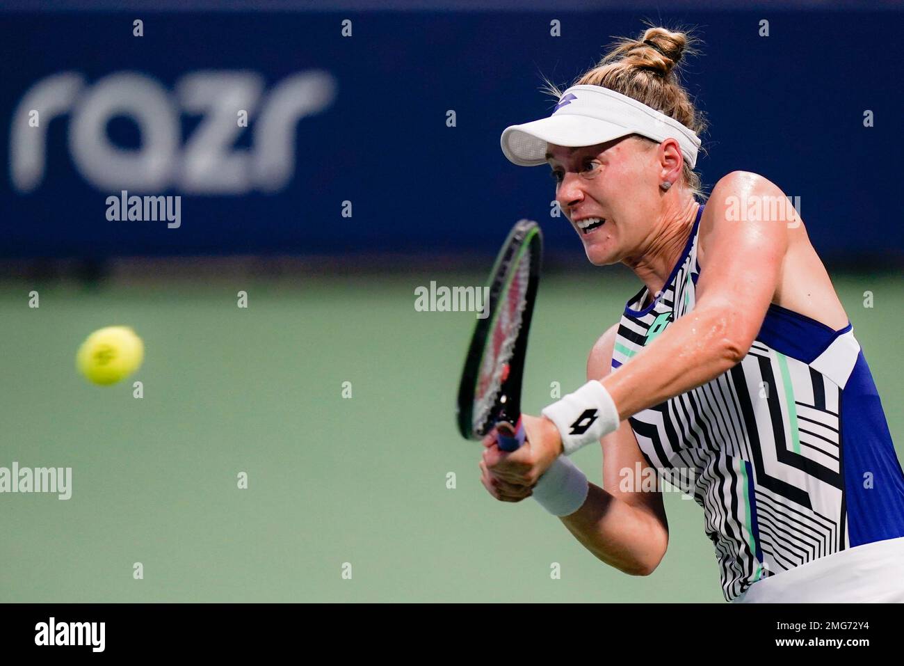 Alison Riske, of the United States, returns to Amanda Anisimova, of the ...