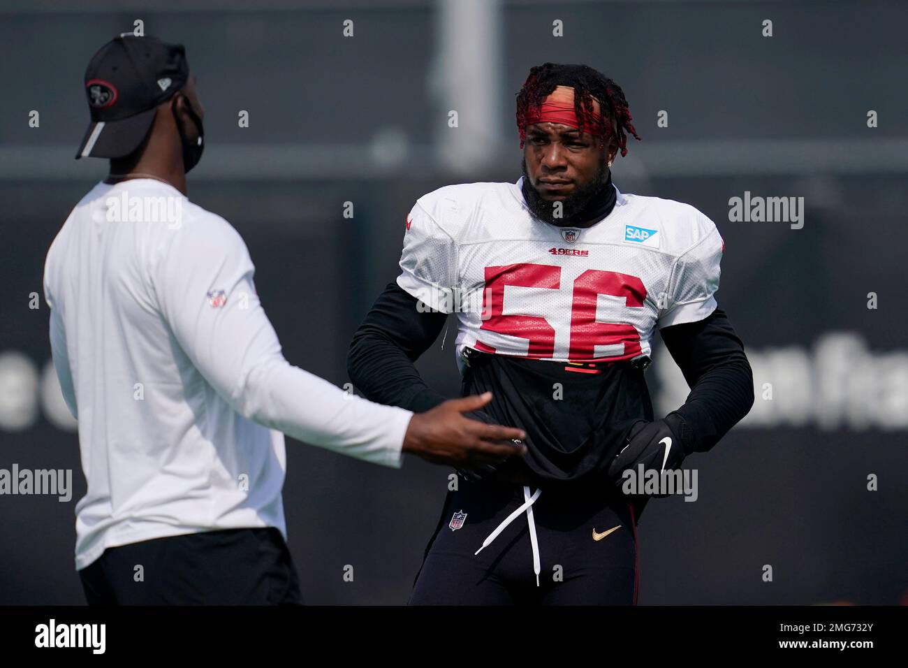 San Francisco 49ers assistant coach DeMeco Ryans, left, talks to Kwon ...
