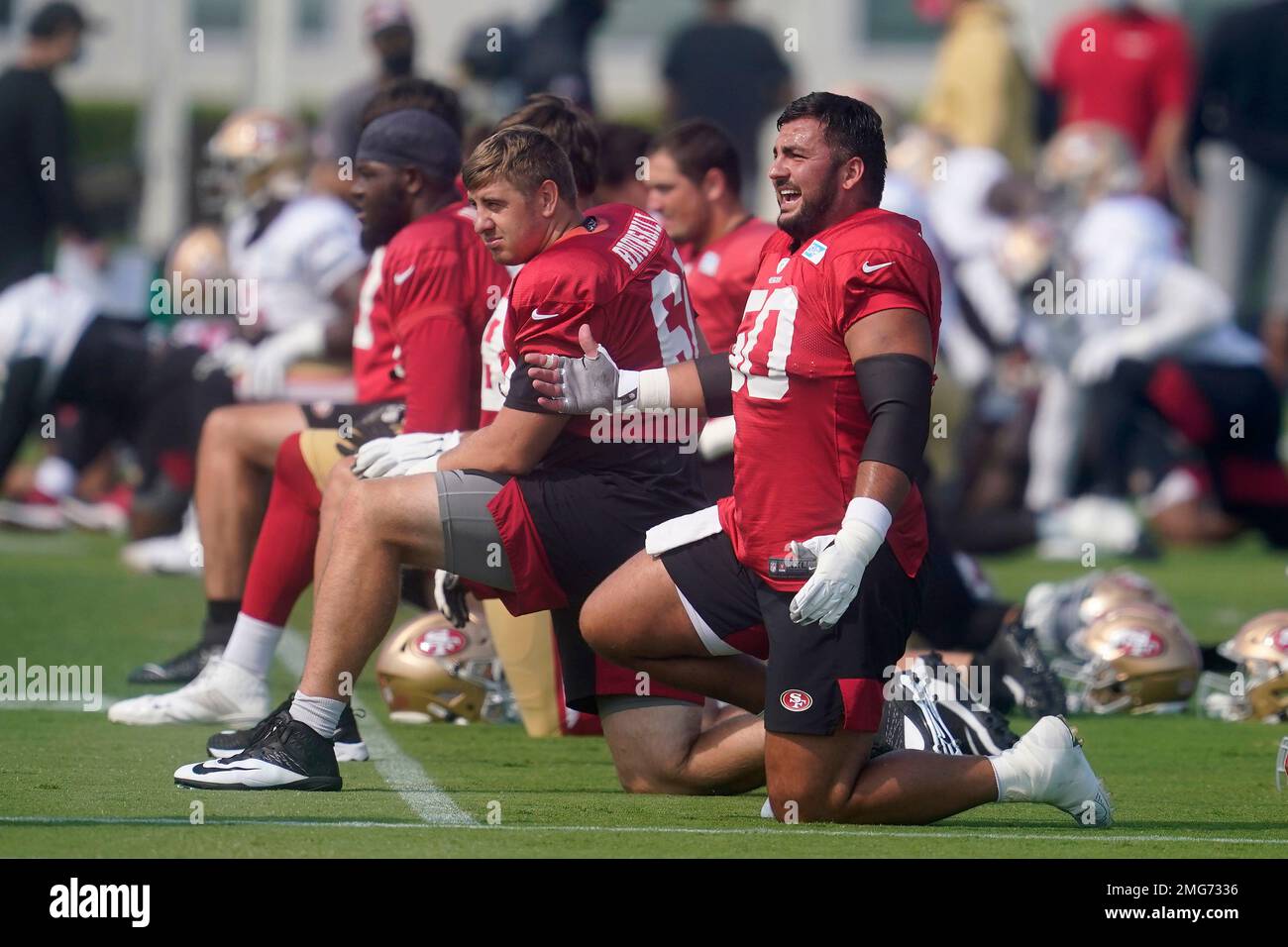 San Francisco 49ers' Hroniss Grasu, right, stretches during NFL ...