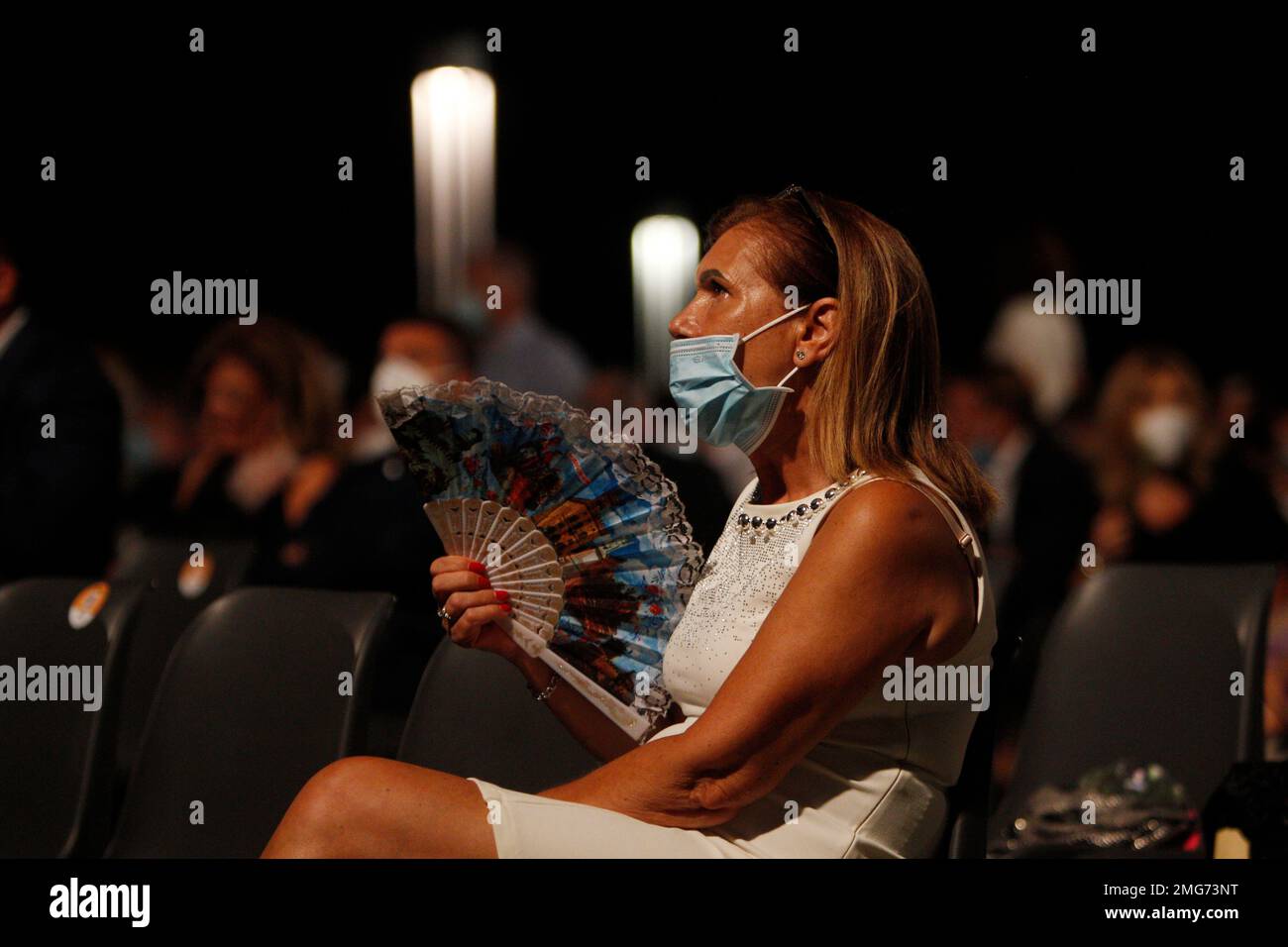 A woman attends the Spanish opera tenor Placido Domingo during a ...