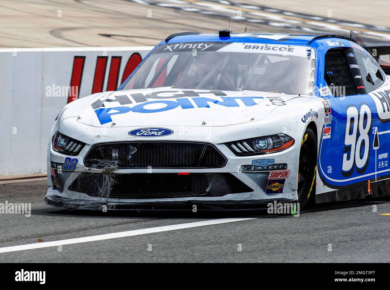 Chase Briscoe (98) is shown with visible damage to the front of his car ...