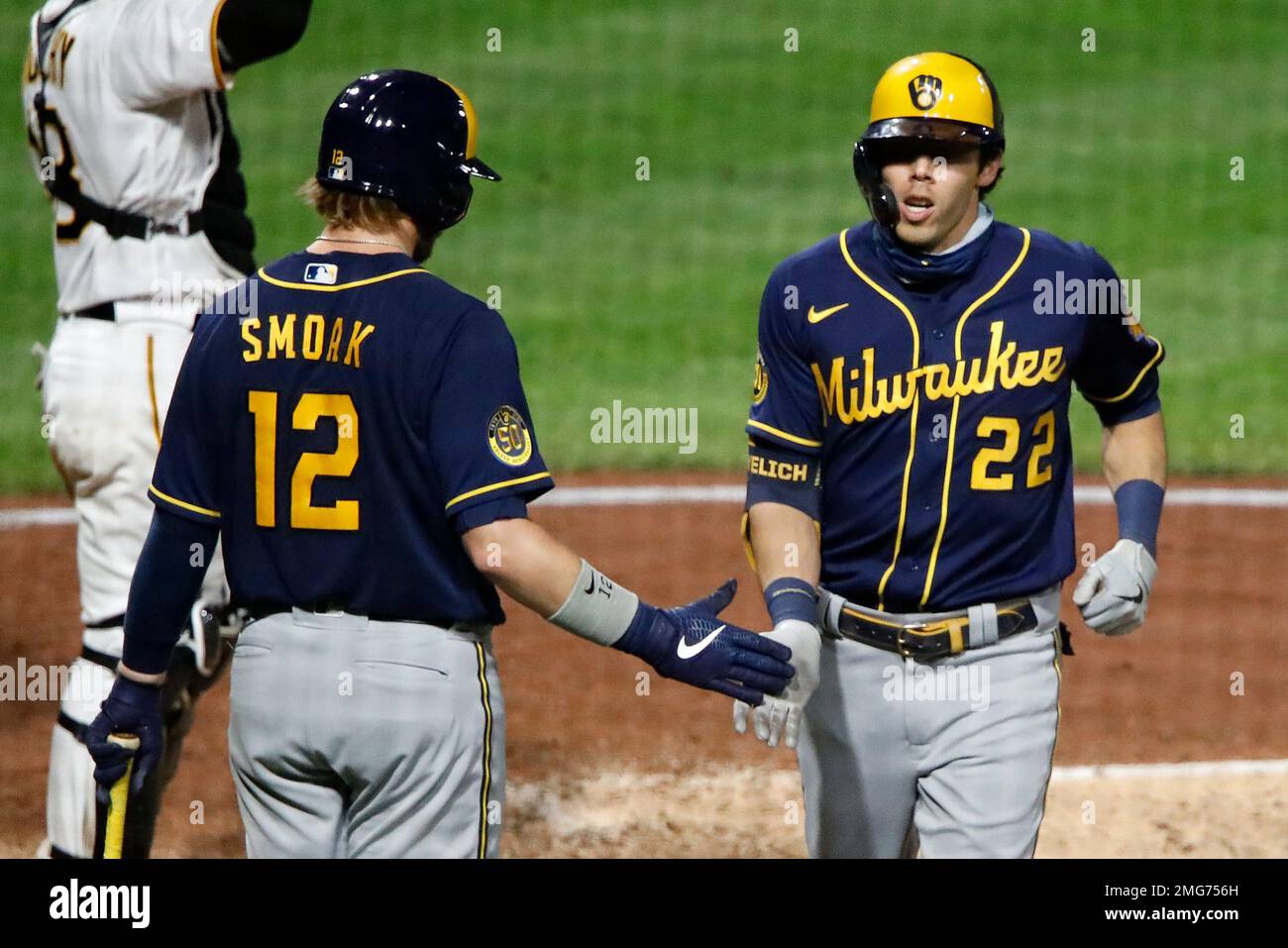 Milwaukee Brewers' Christian Yelich (22) celebrates with Justin Smoak ...