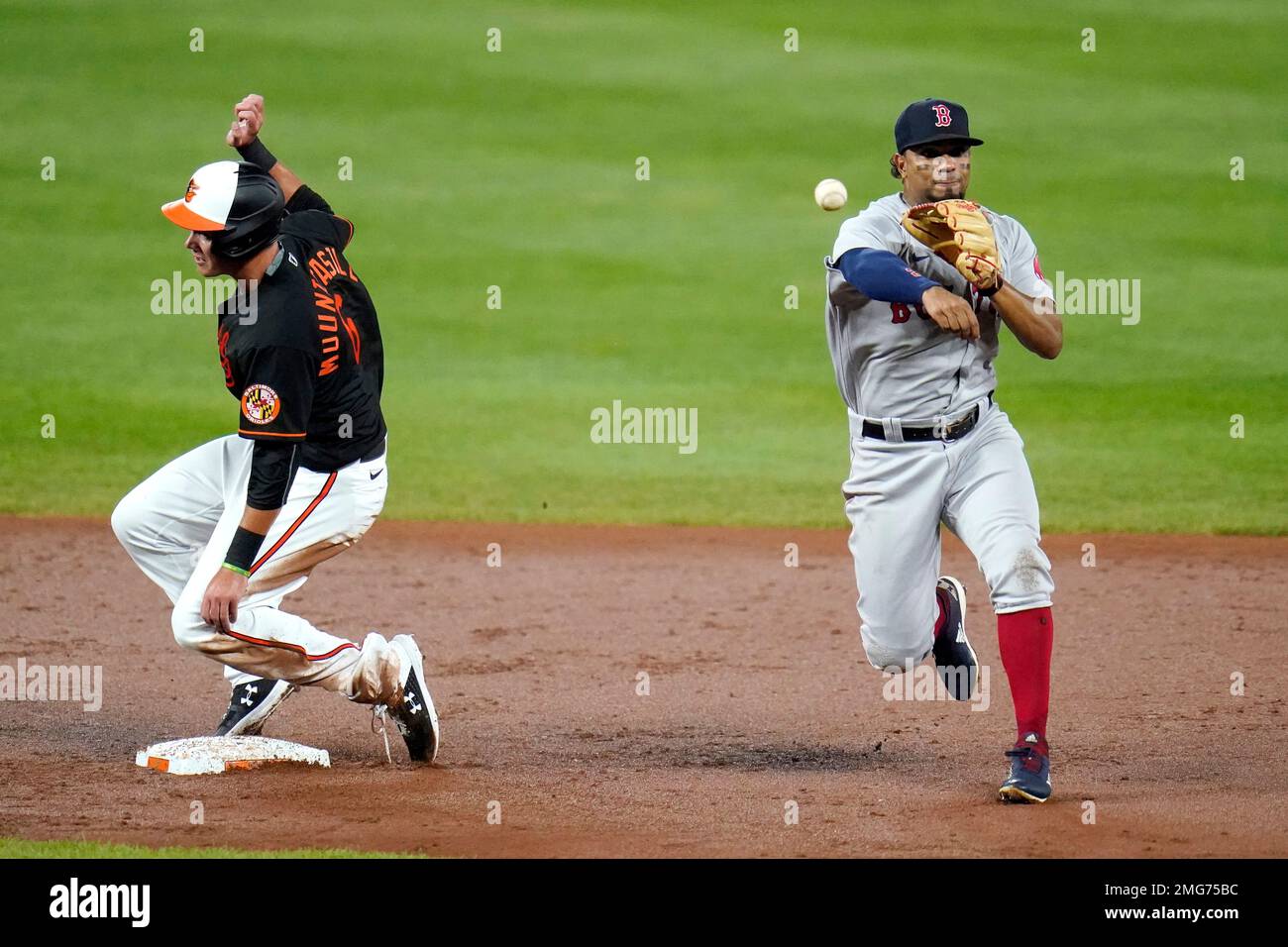 Boston Red Sox shortstop Xander Bogaerts, right, turns a double play as ...