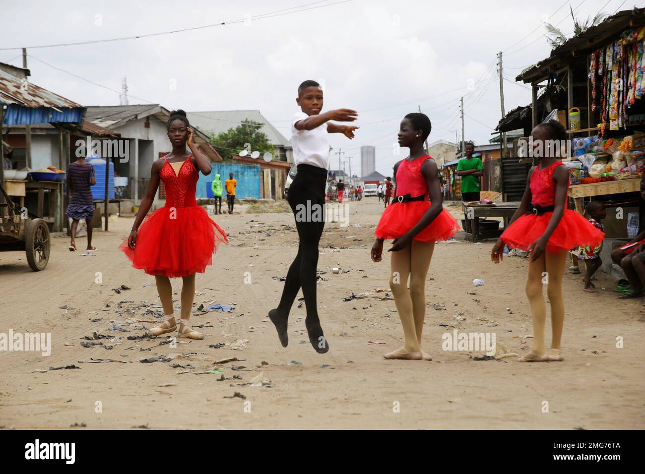 Ballet student Anthony Mmesoma Madu, center, dances in the street as ...
