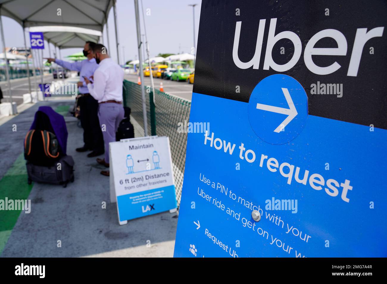 Travelers request an Uber ride at Los Angeles International Airport's ...
