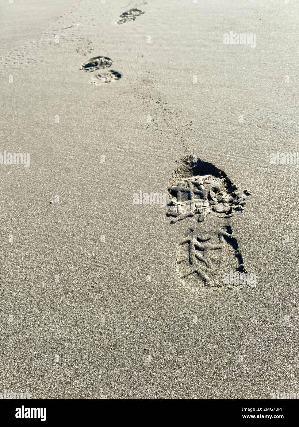 shoe prints on the sand beach Stock Photo - Alamy