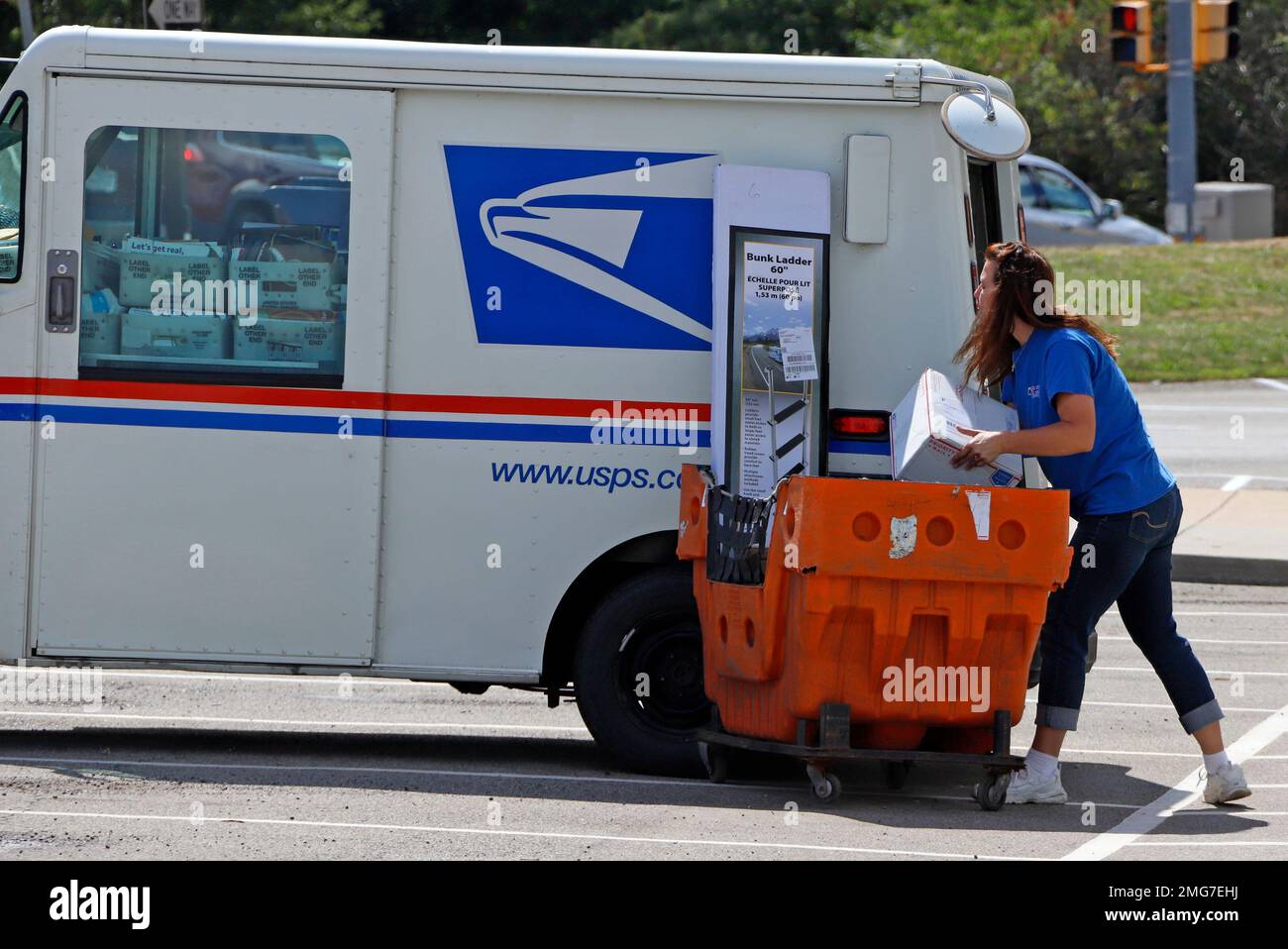 A postal worker loads a delivery vehicle at the United States Post ...