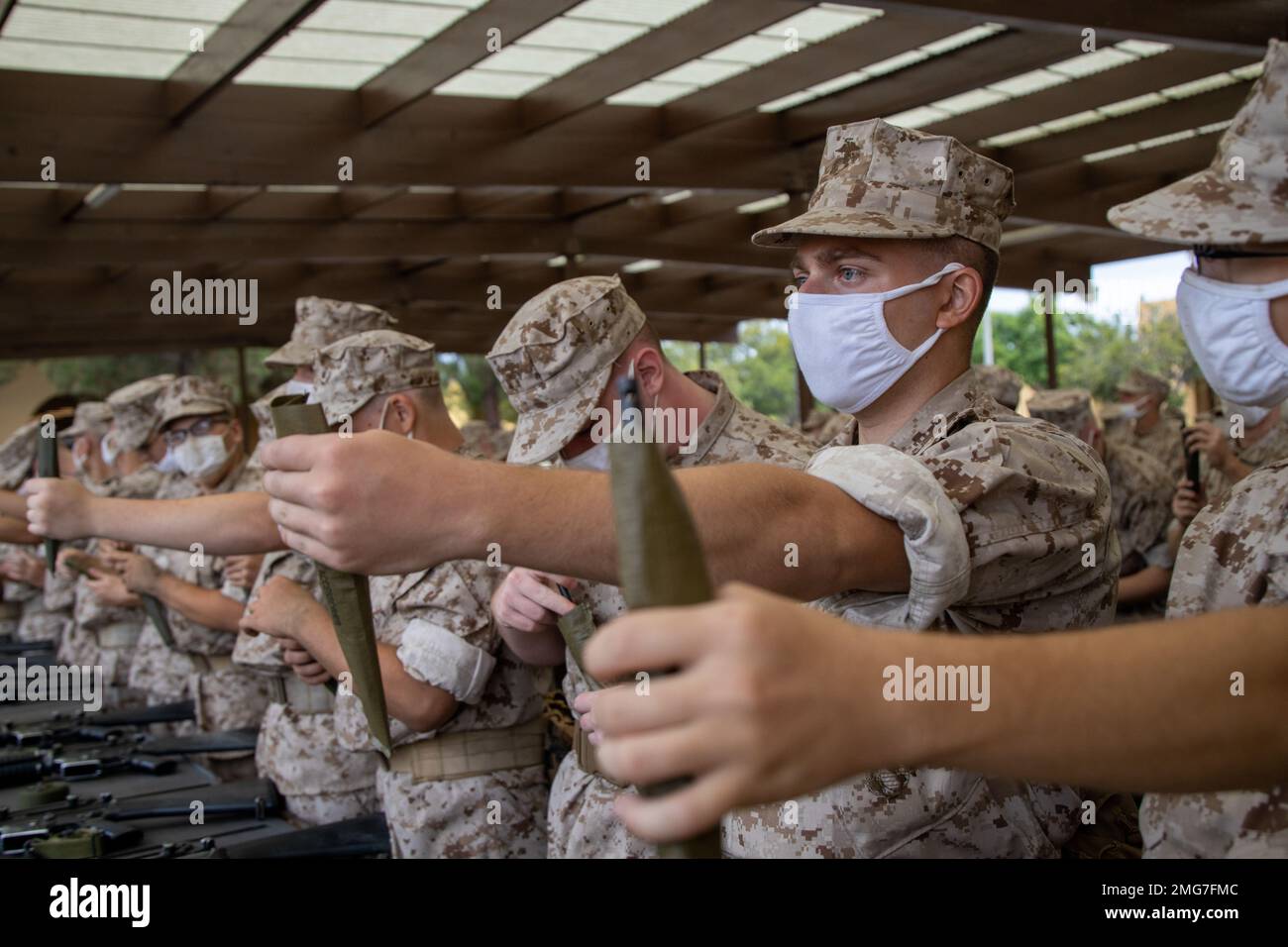 U.S. Marine Corps recruits with Hotel Company, 2nd Recruit Training Battalion, hold up their ...