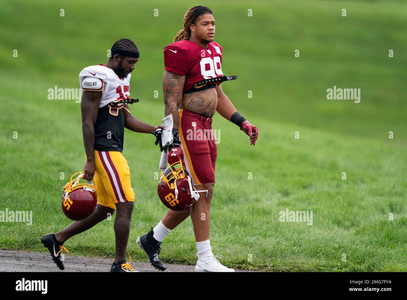 Washington wide receiver Steven Sims Jr., (15), left, and defensive end ...