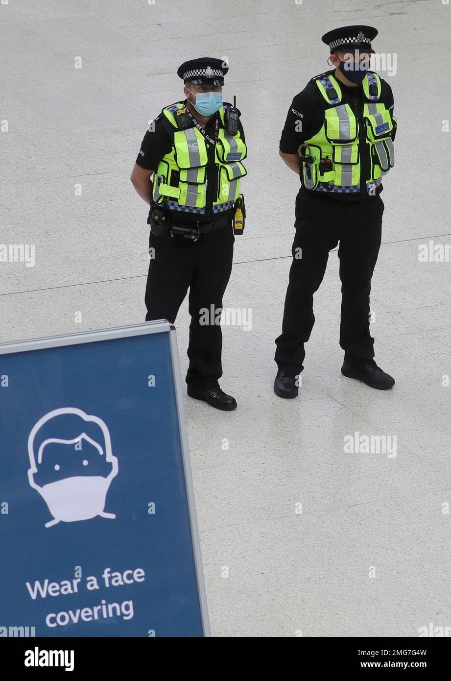 Police officers observe a minutes silence to remember those involved in ...
