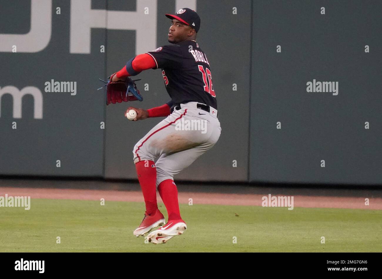 Washington Nationals' Victor Robles sets back to throw after catching a ...