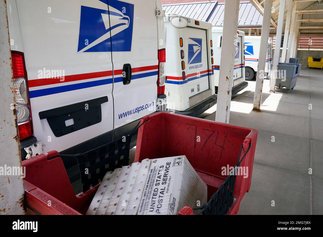 Mail delivery vehicles are parked outside a post office in Boys Town ...