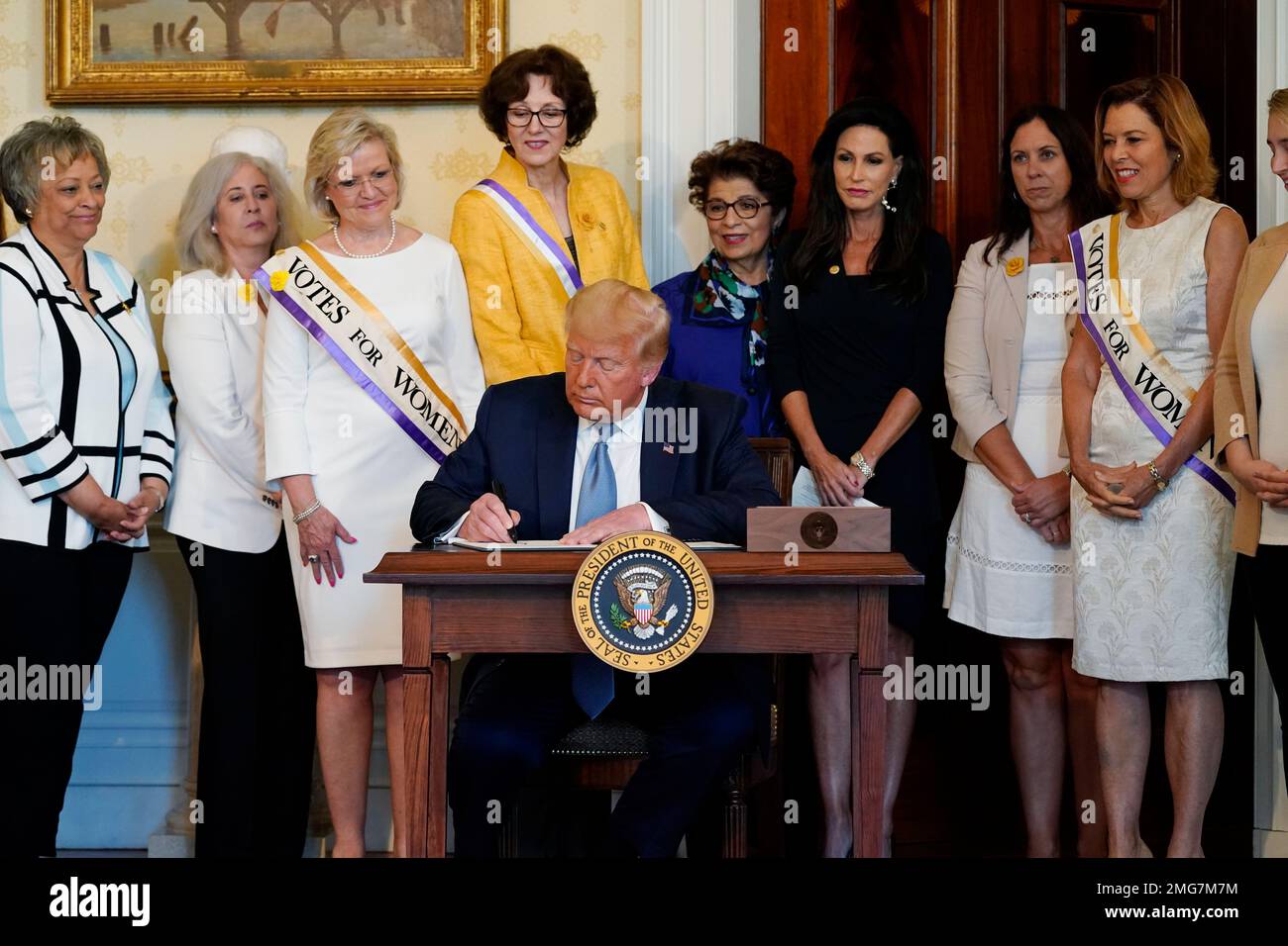 President Donald Trump signs a proclamation recognizing the 100th ...