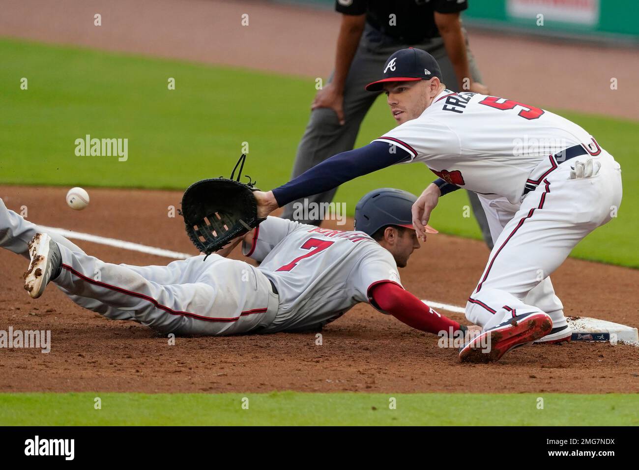 Washington Nationals' Trea Turner (7) dives back to first base as ...