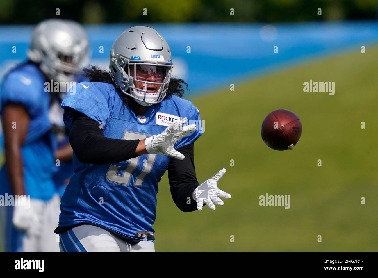 Detroit Lions linebacker Jahlani Tavai catches during drills at the ...