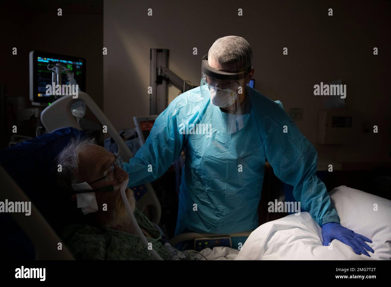 Spencer Cushing, 29, tends to David Feinour, a 71-year-old COVID-19 ...