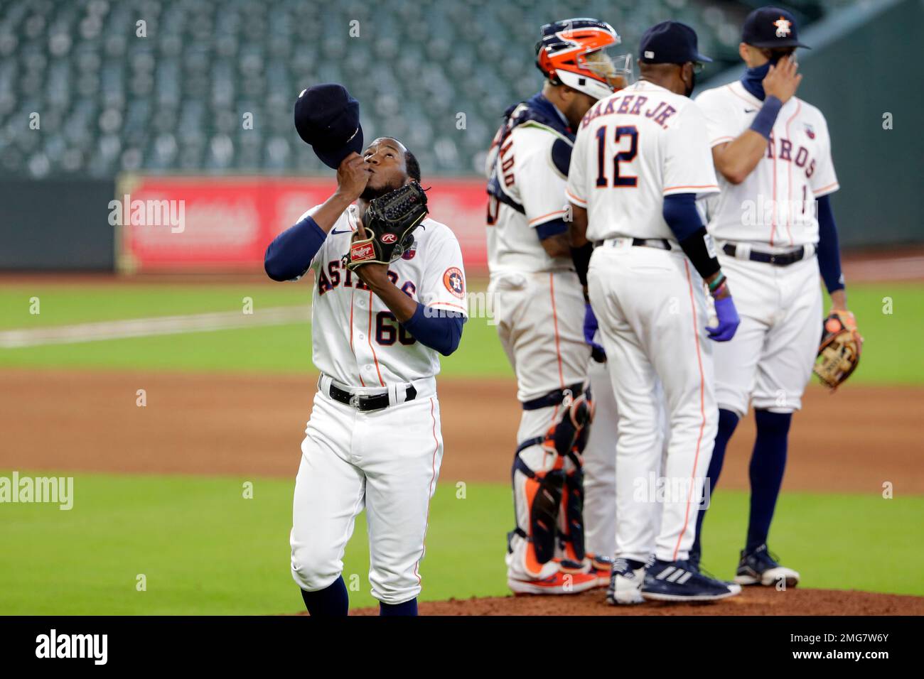 Houston Astros relief pitcher Enoli Paredes (60) kisses his hand as he ...
