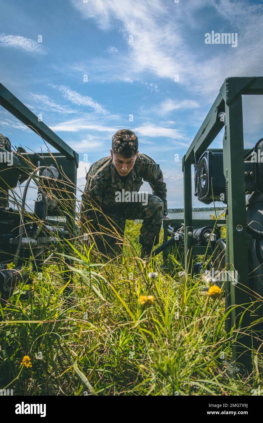 U.S. Marine Corps Lance Cpl. Ben Holstein, a water support technician ...