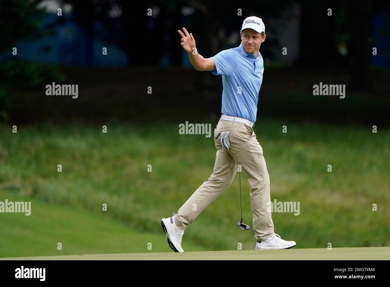 Peter Malnati waves after dropping a birdie putt during the final round ...